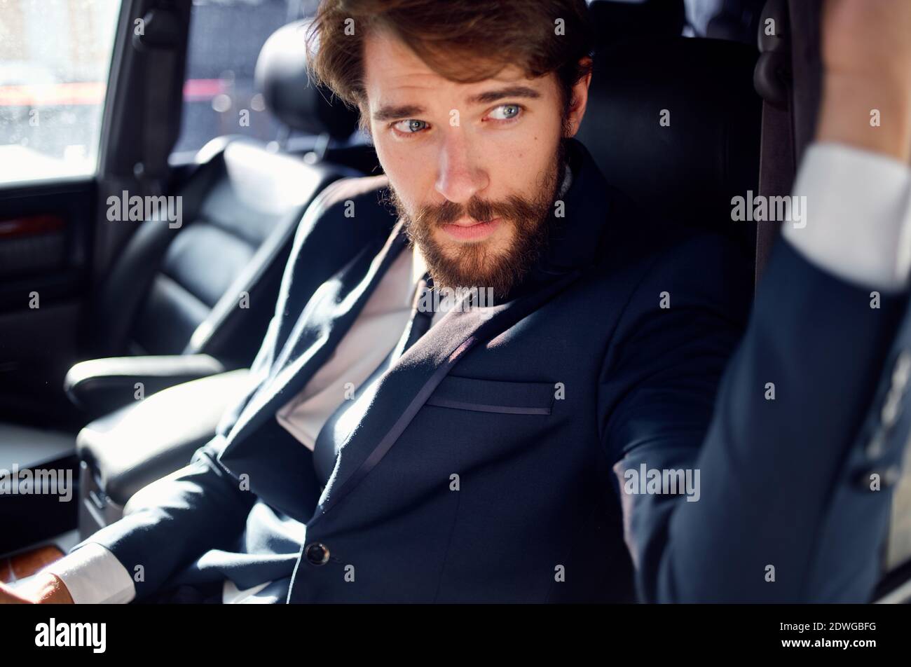 successful young man driving a car in a suit trip lifestyle Stock Photo ...