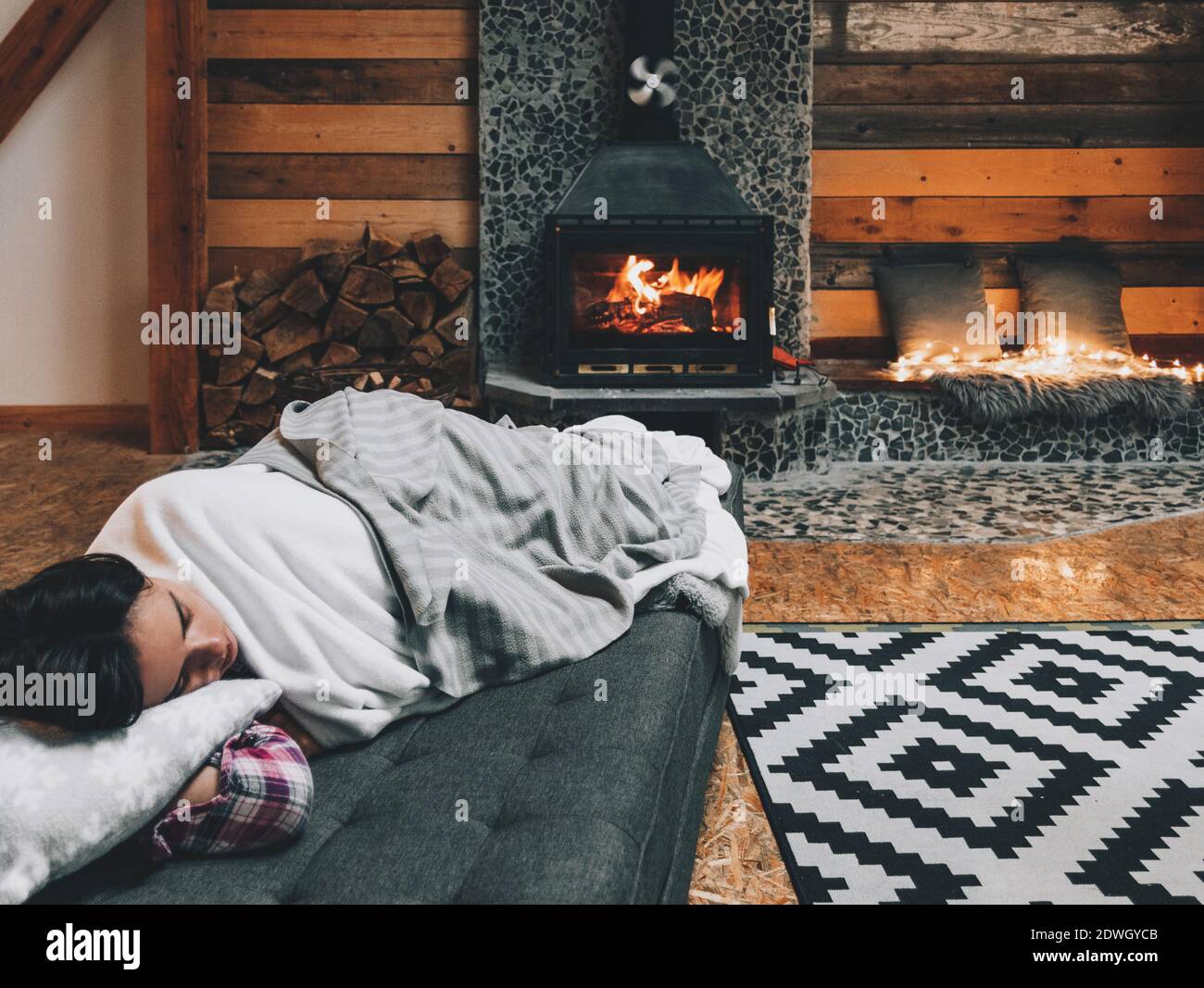 Woman sleeping fireplace hi-res stock photography and images - Alamy