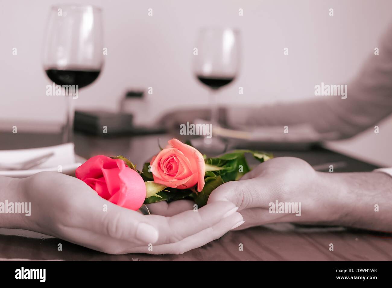 Male and female hands with roses. Portrait black and white with ...