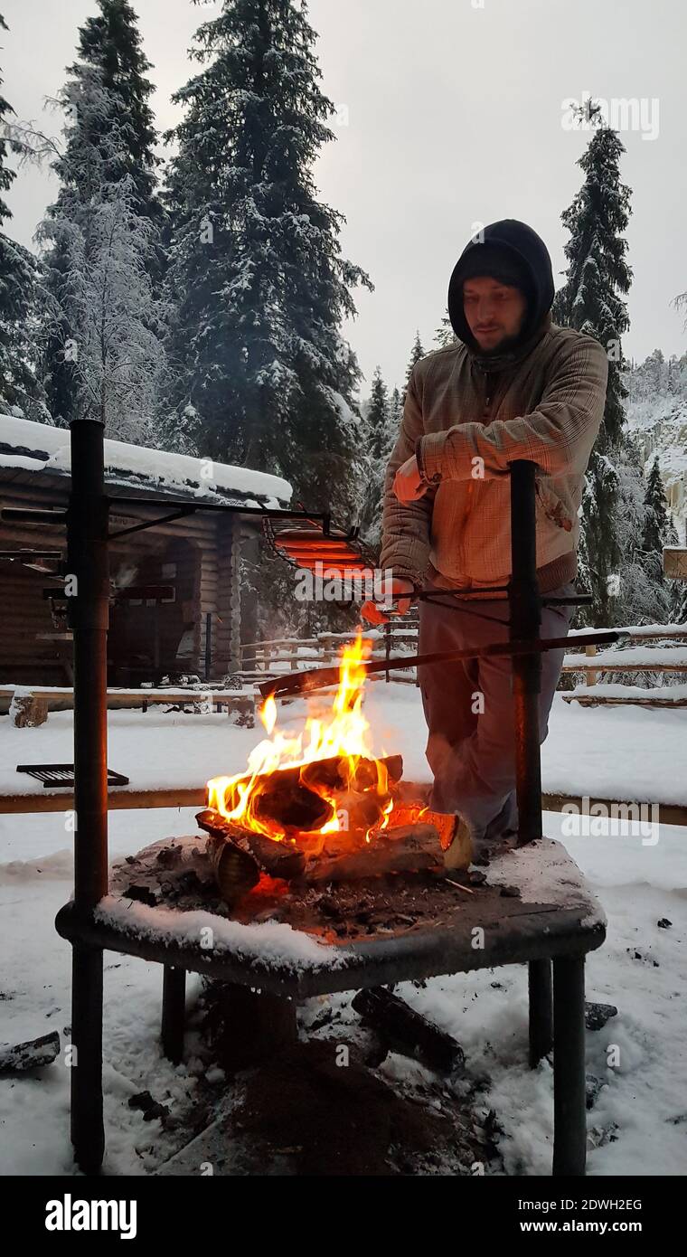 Man cooking over campfire in snow hi-res stock photography and images ...