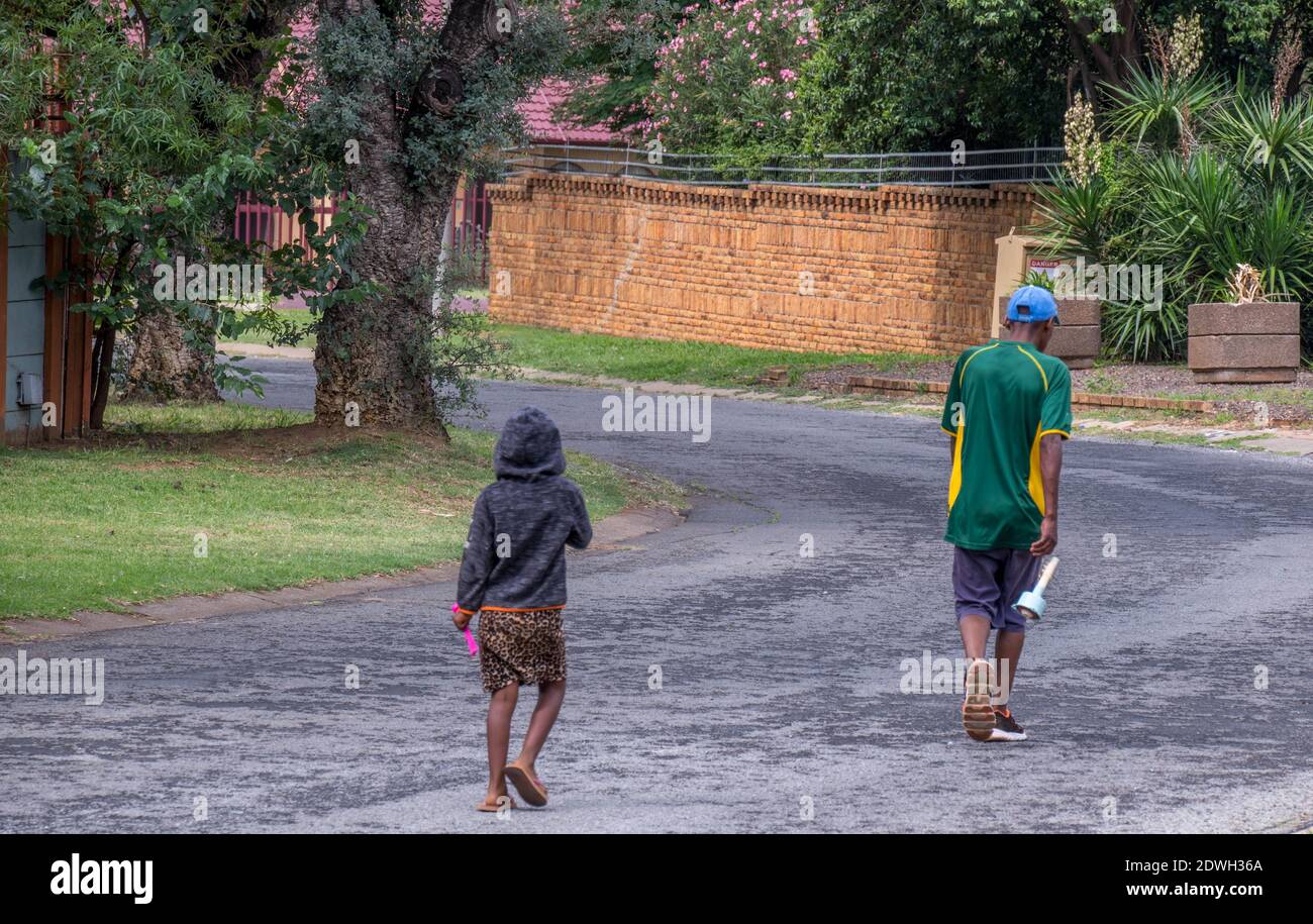 Johannesburg, South Africa - a homeless black father and son walk down ...