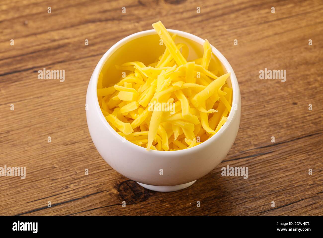 Shredded yellow cheese in the bowl for cooking Stock Photo - Alamy