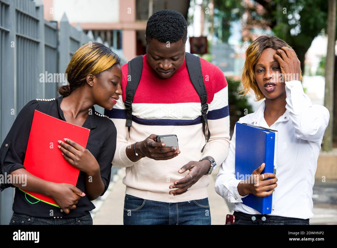 group of students with mobile phone, smiling Stock Photo - Alamy