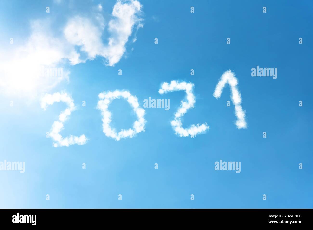 Numbers 2021 symbol inscription on a background of blue sky from white ...