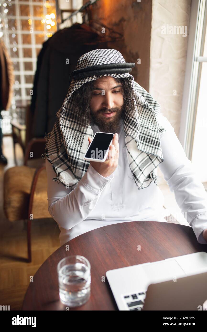 Message. Arabian businessman working in office, business centre using ...