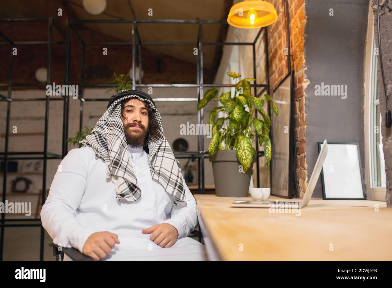 Thoughtful. Arabian businessman working in office, business centre ...