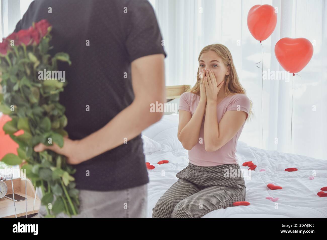 Man giving Rose flower to girl for Valentine's day Stock Photo - Alamy