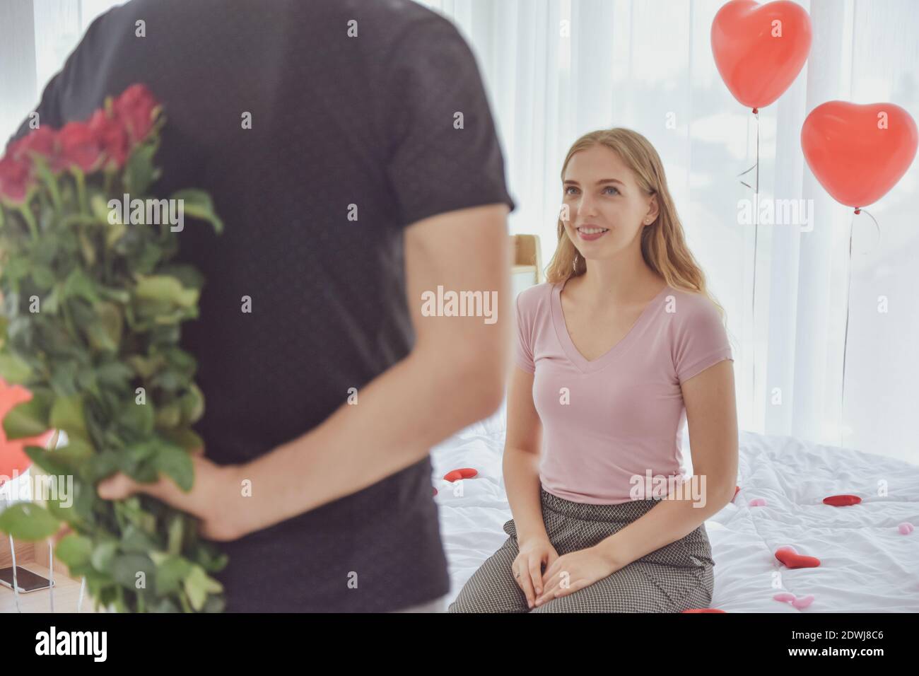 Man giving Rose flower to girl for Valentine's day Stock Photo - Alamy