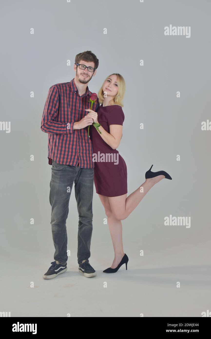 Young Couple giving Rose flower on white background Stock Photo - Alamy