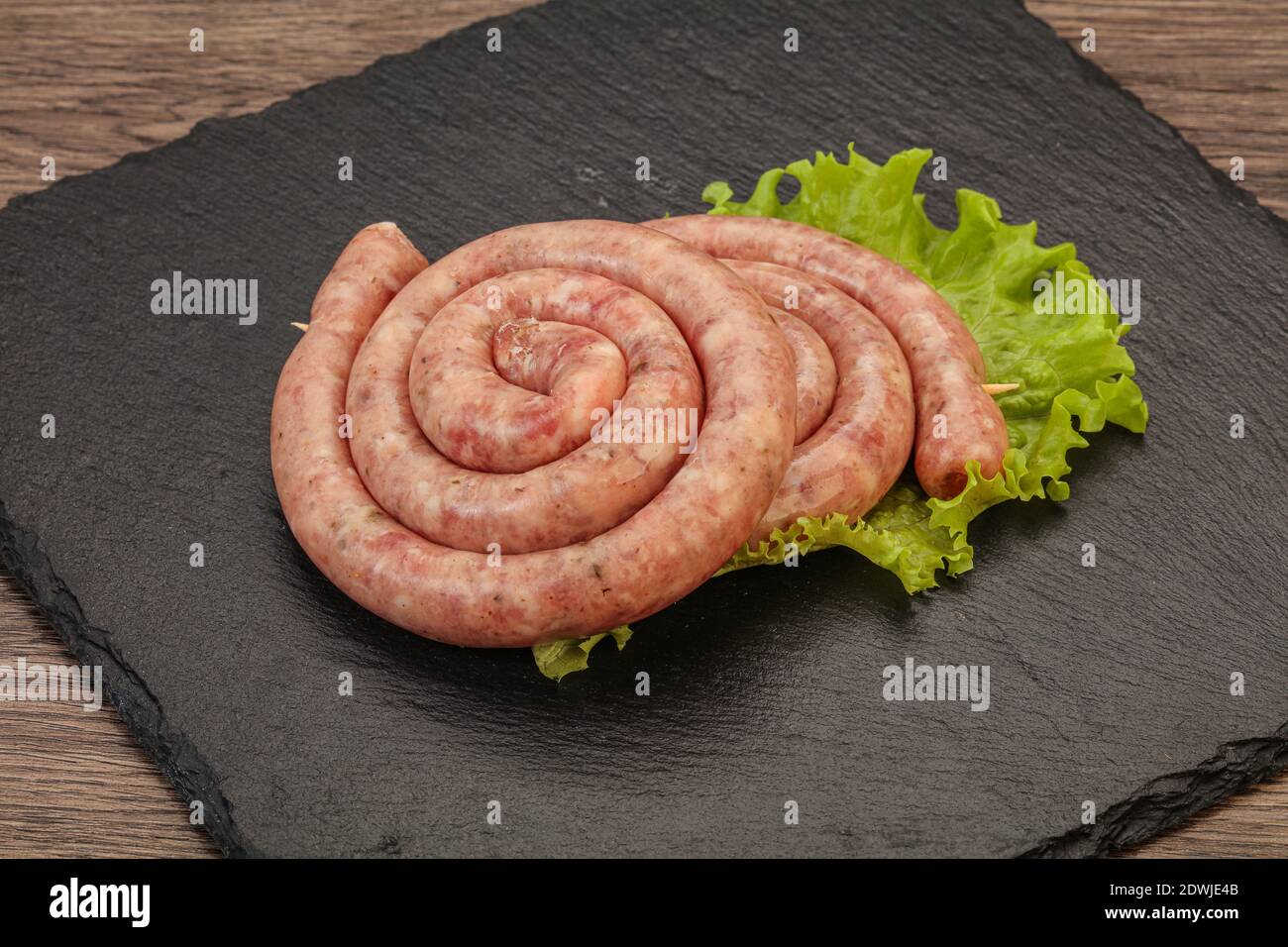 Raw pork sausage ring for grill Stock Photo - Alamy