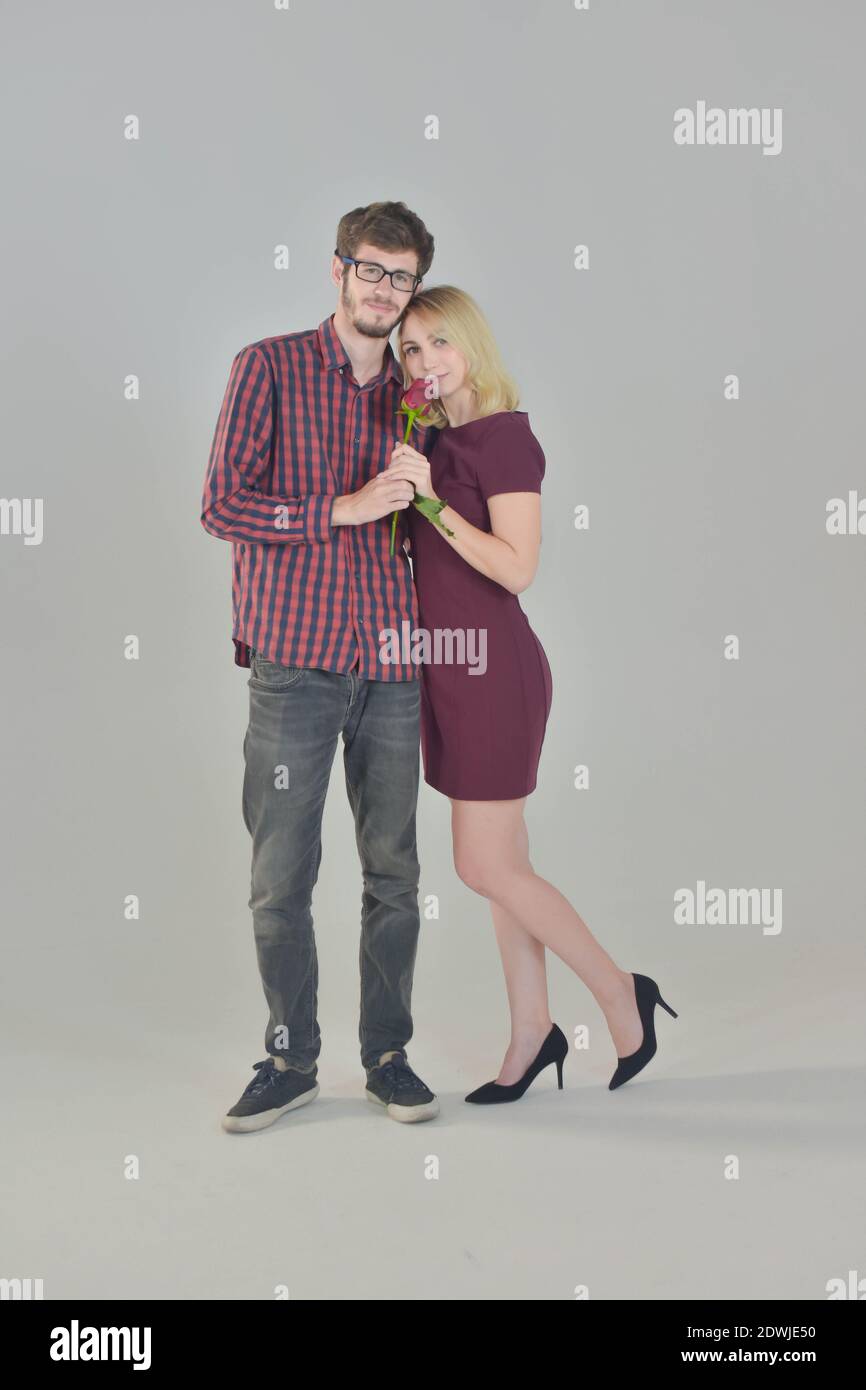 Young Couple giving Rose flower on white background Stock Photo - Alamy