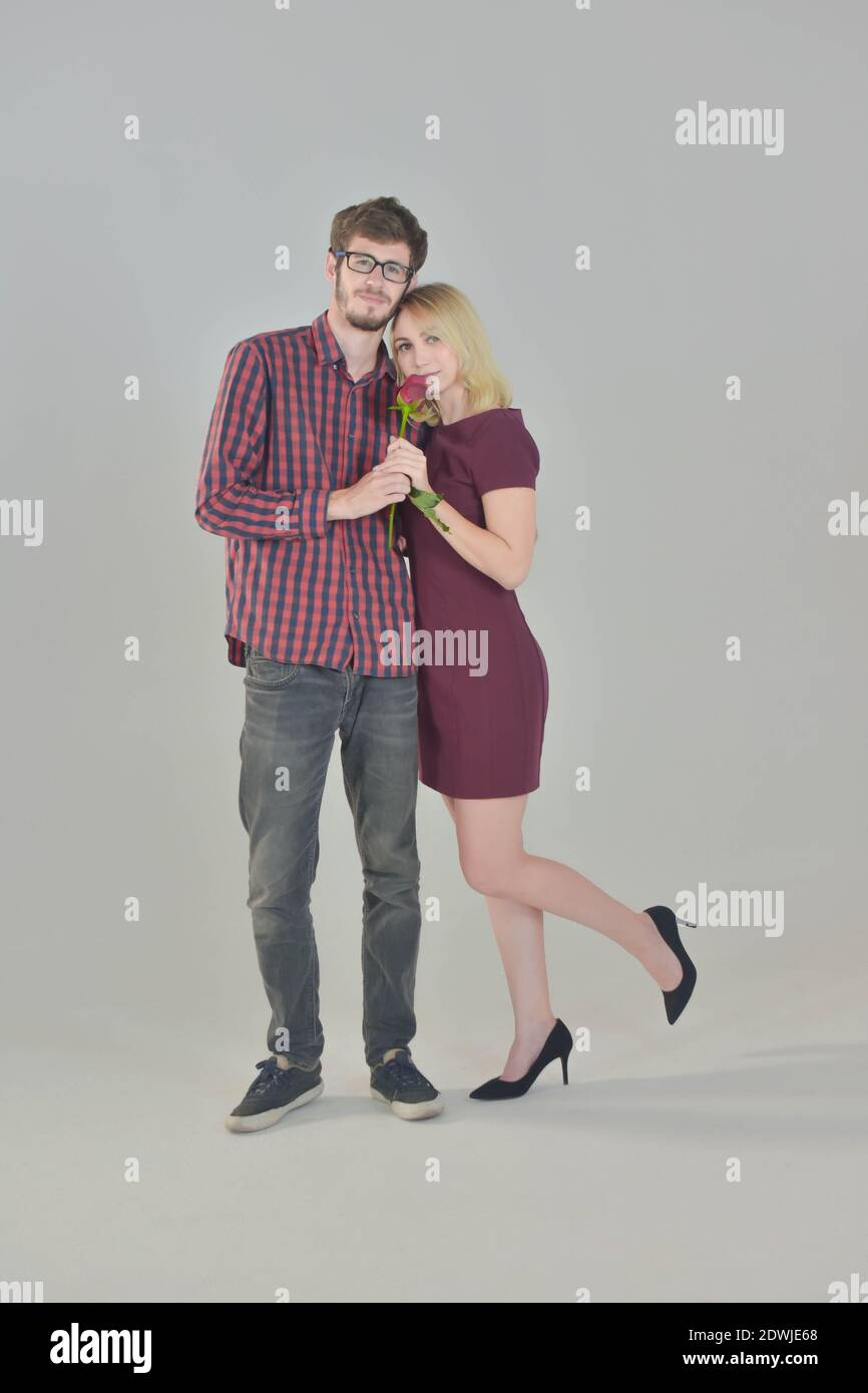 Young Couple giving Rose flower on white background Stock Photo - Alamy