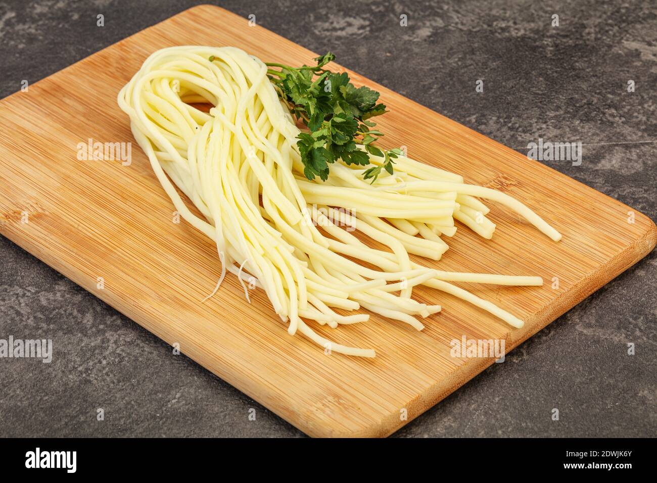 Chechil spaghetti cheese snack over board Stock Photo - Alamy