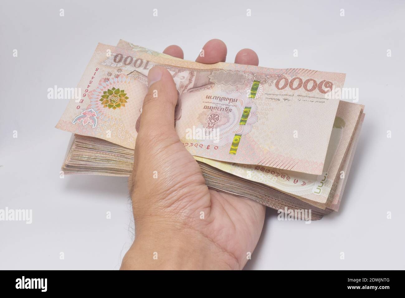 Hand holding money banknote on white background Stock Photo - Alamy