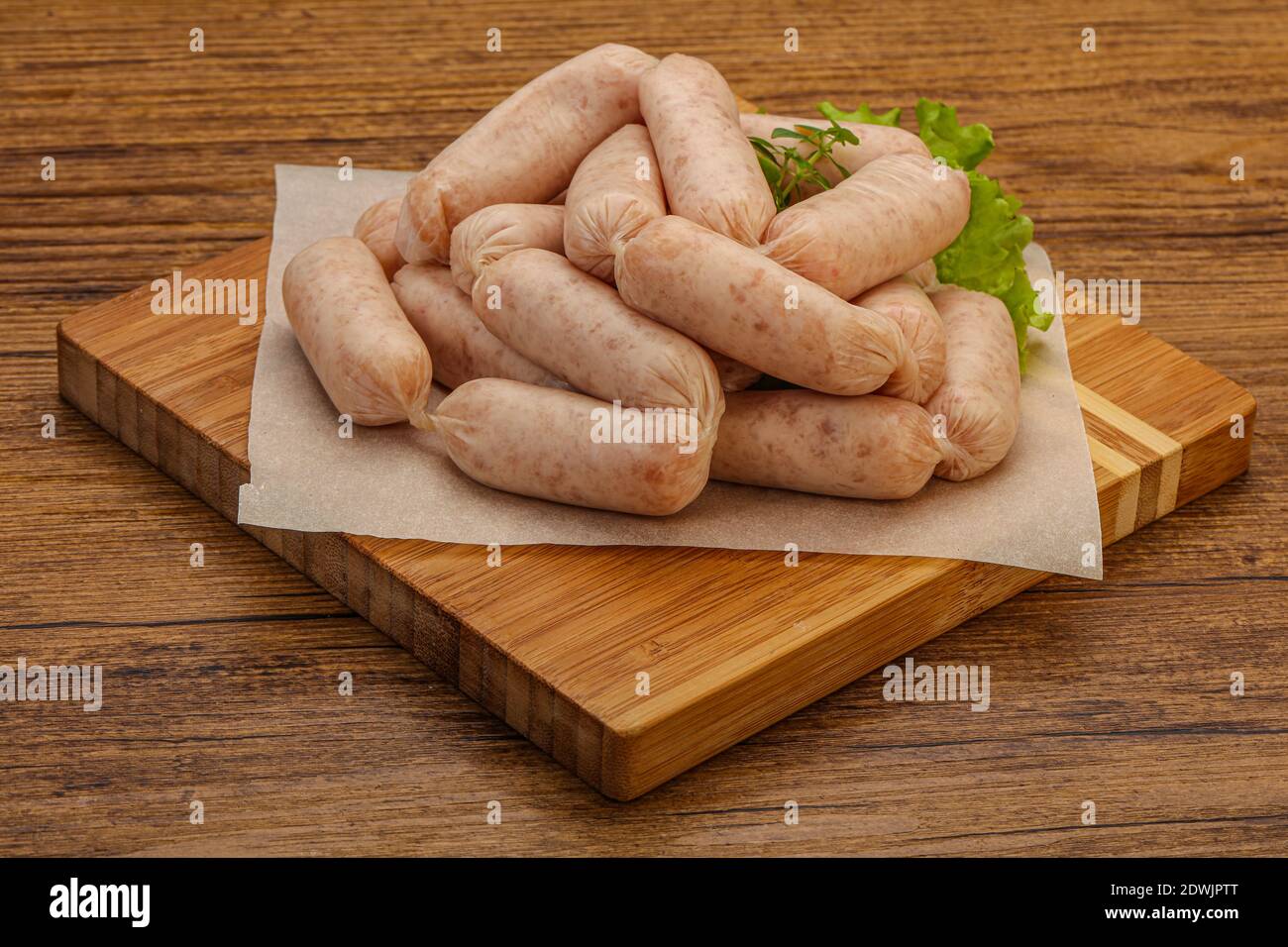 Raw natural chicken baby sausages for roast Stock Photo - Alamy