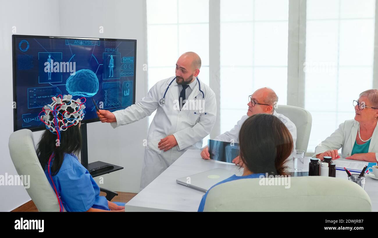 Female nurse wearing scaning headset for brain activity during ...