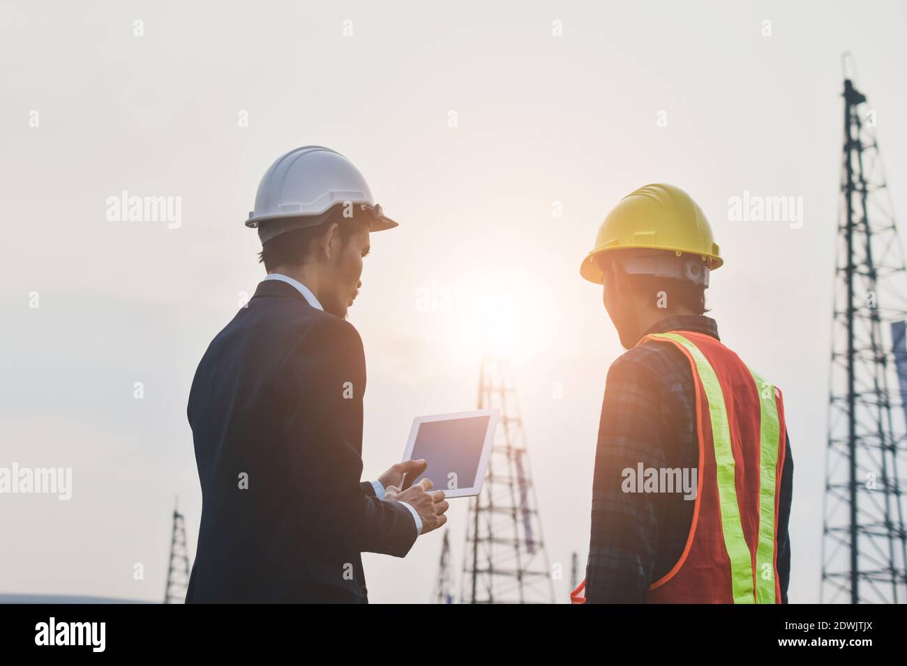 Project manager holding tablet communication with Construction ...