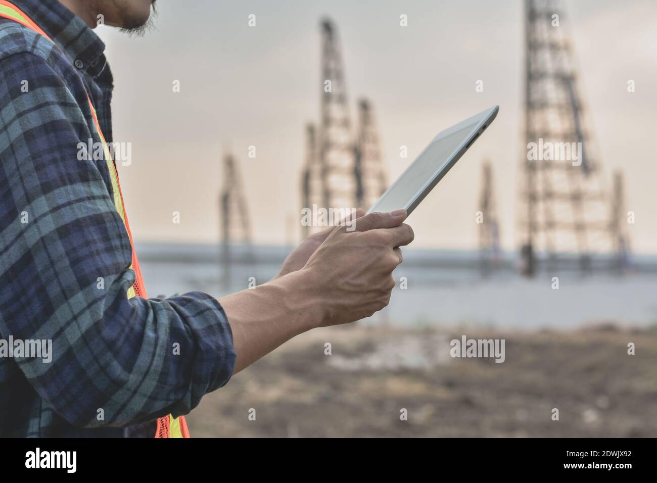 Close up Construction Engineering holding tablet building estate ...