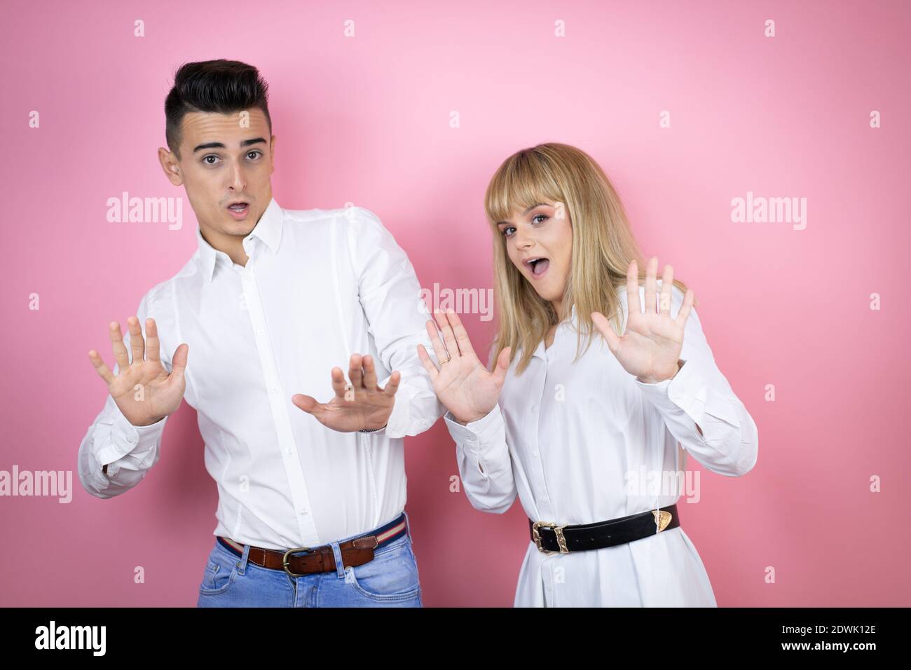 Young couple of girlfriend and boyfriend over isolated pink background ...