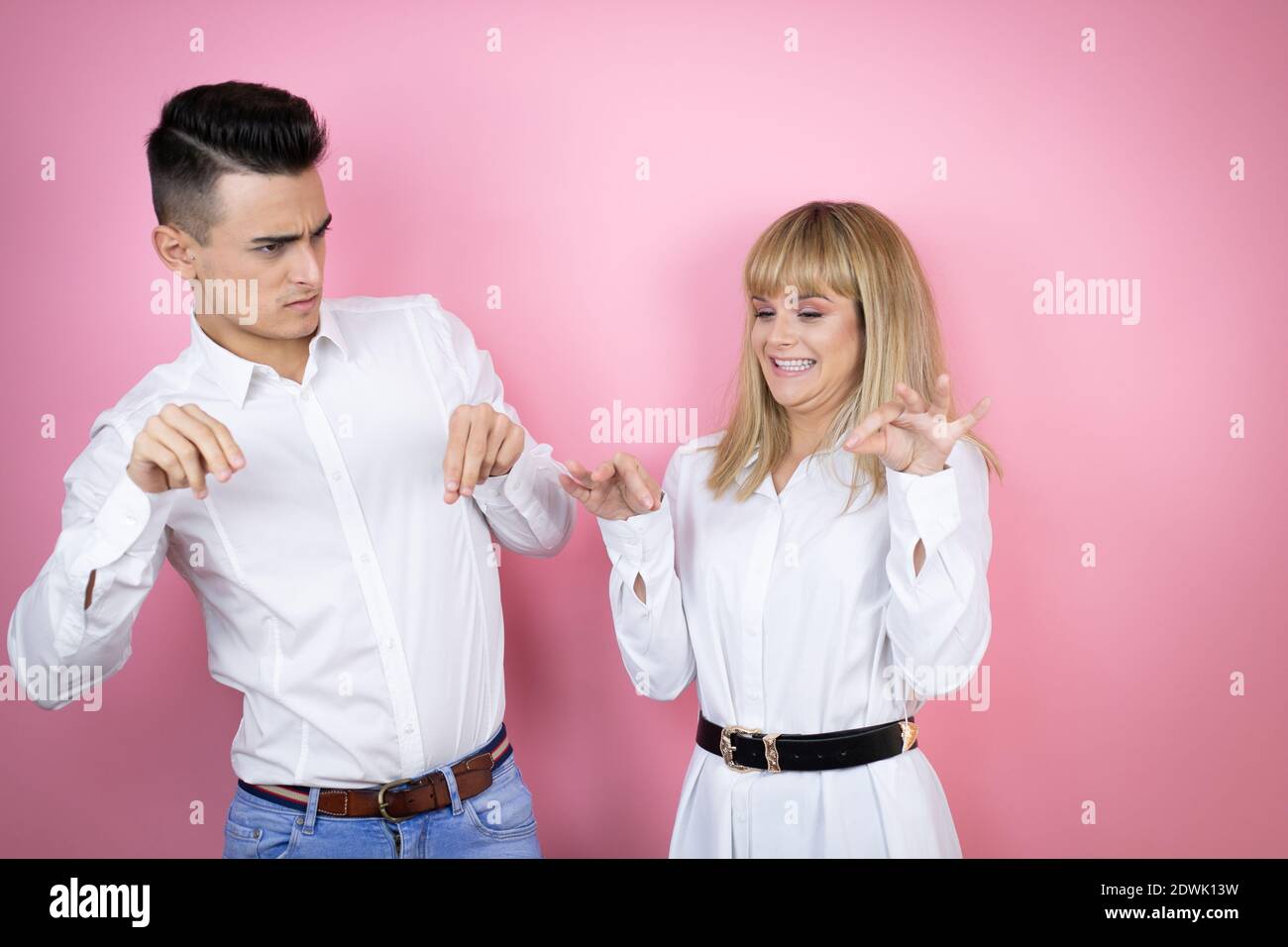 Young couple of girlfriend and boyfriend over isolated pink background ...