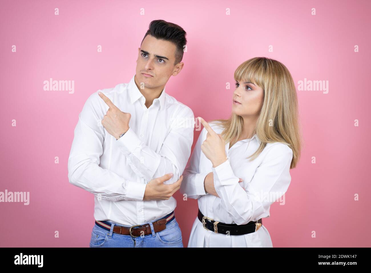 Young couple of girlfriend and boyfriend over isolated pink background ...