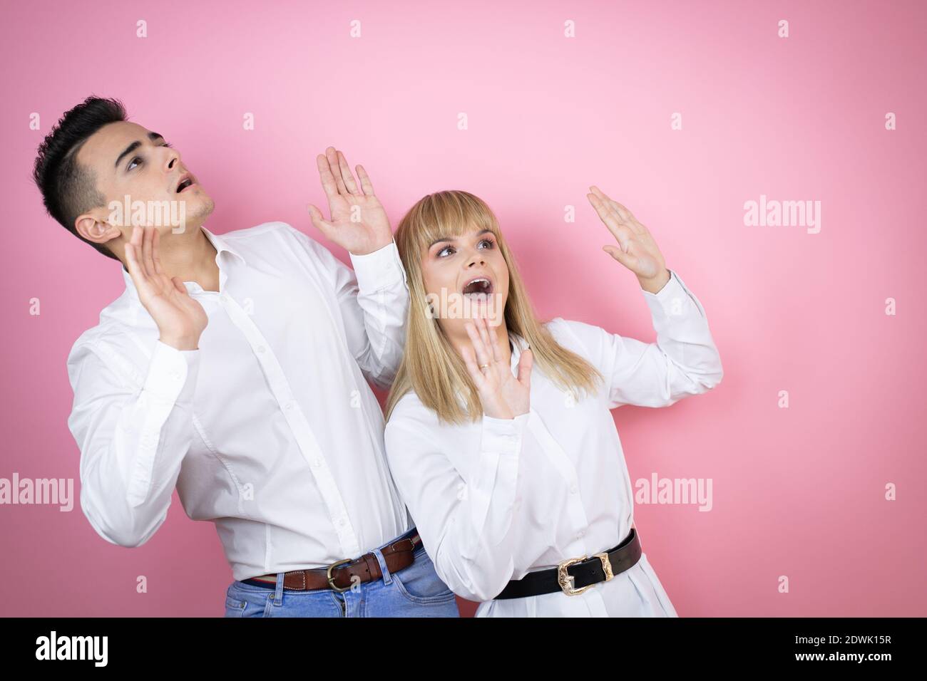 Young couple of girlfriend and boyfriend over isolated pink background ...