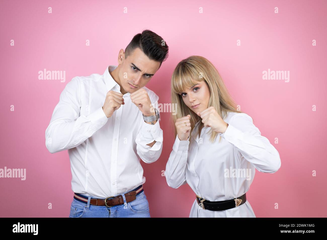 Young couple of girlfriend and boyfriend over isolated pink background ...