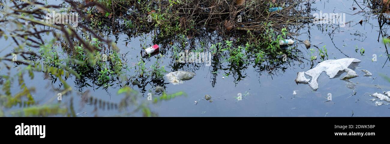 Trash thrown away in water, environmental problems. Nature disaster ...