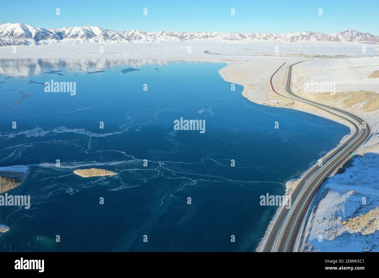 An aerial view of the spectacular scenery of the largest and highest alpine lake, Sayram Lake ...