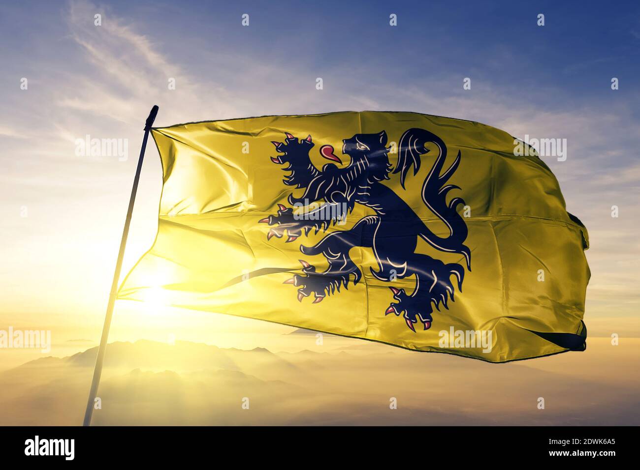 Flanders region of Belgium flag waving on the top sunrise mist fog ...