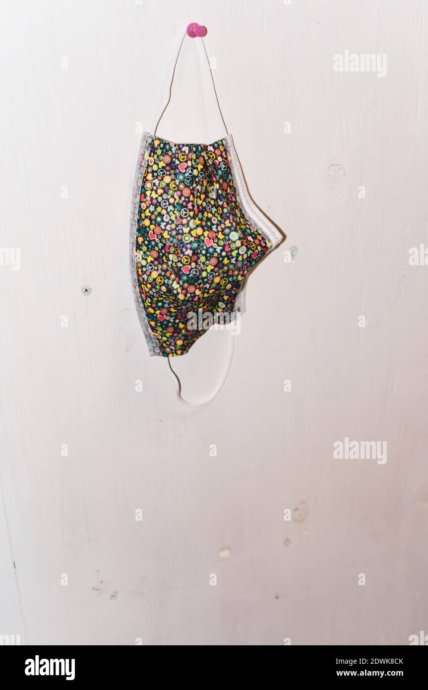 A vertical shot of a colorful facial mask hanging on a wall - new ...