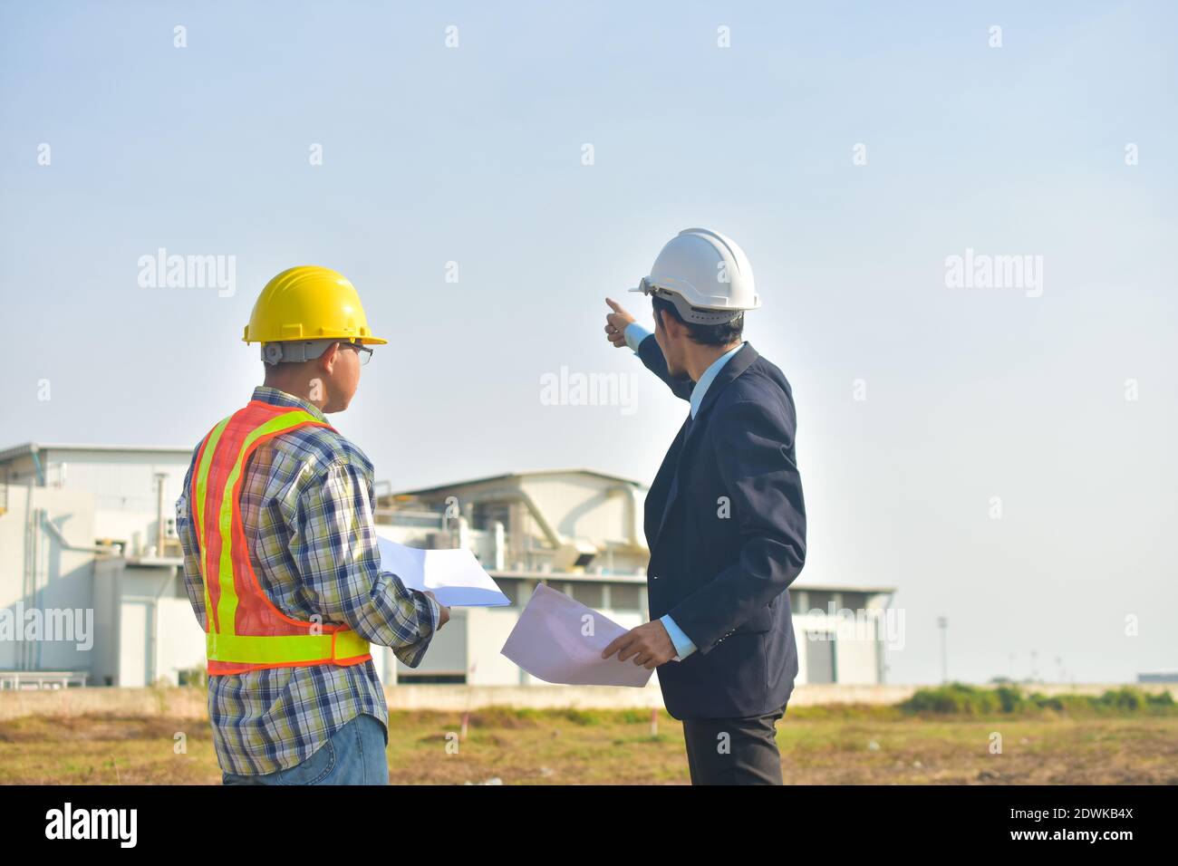 Project Manager taking with Engineer construction plan project building ...
