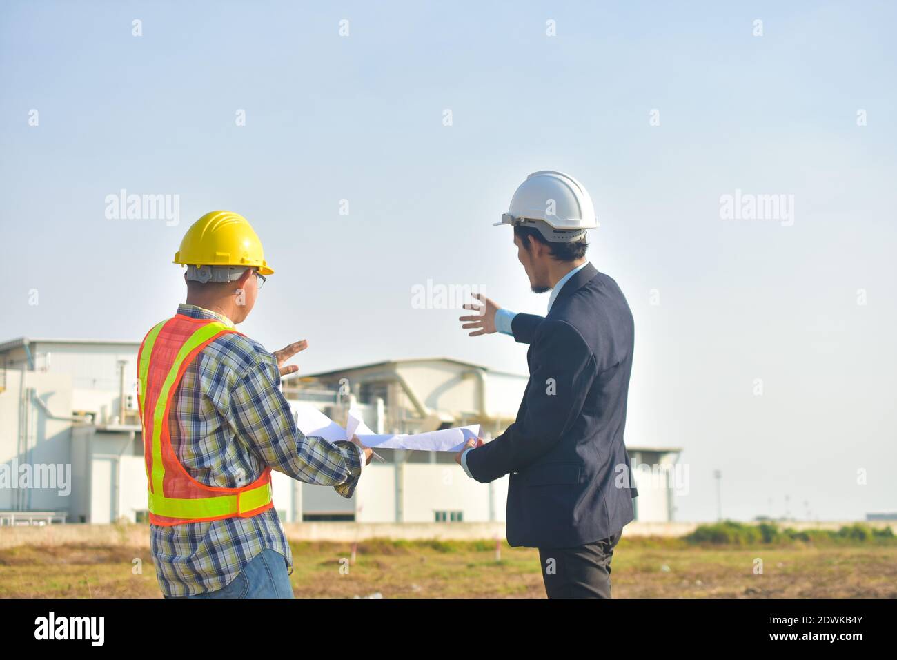 Project Manager taking with Engineer construction plan project building ...