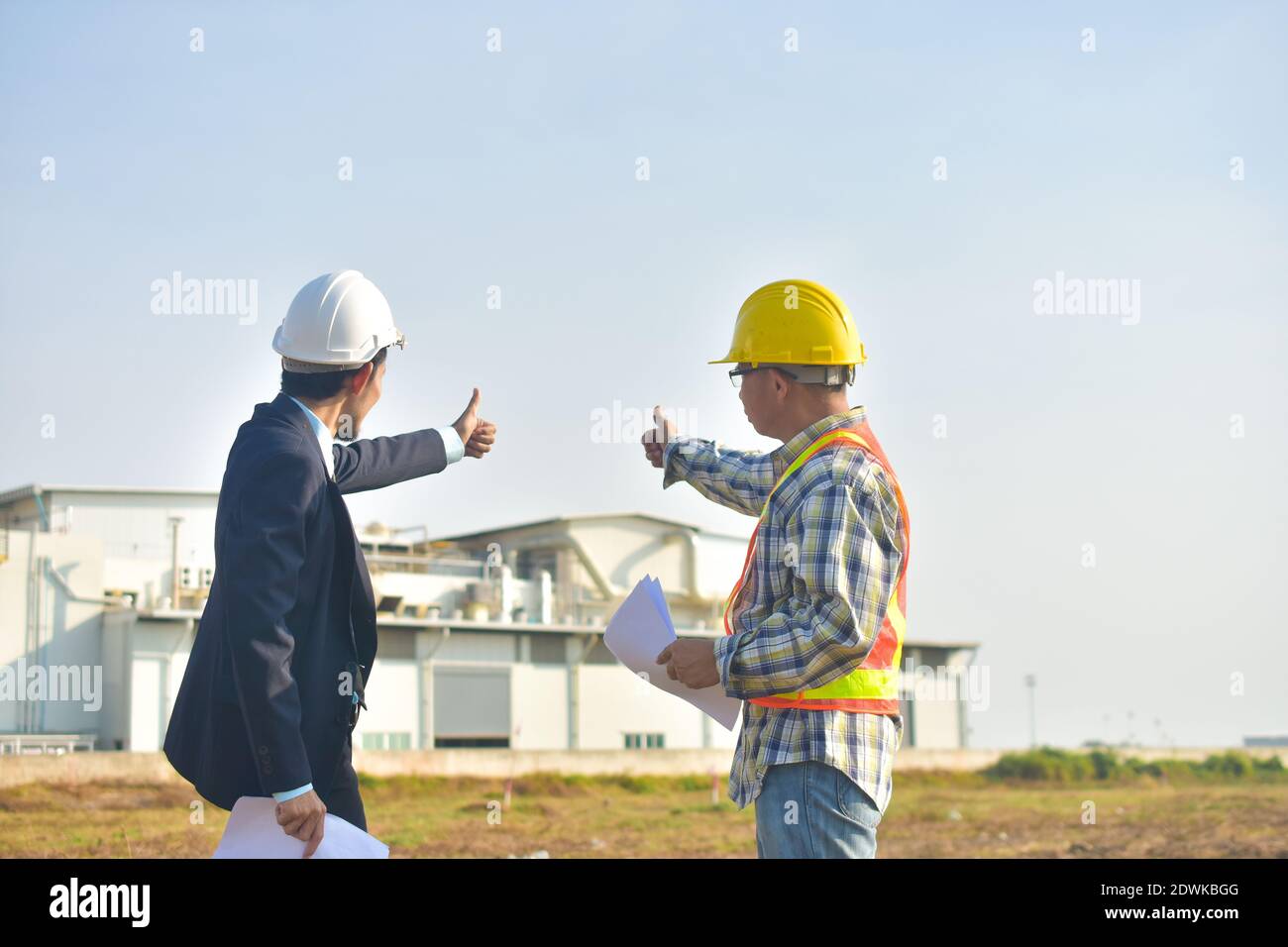 Project Manager taking with Engineer construction plan project building ...
