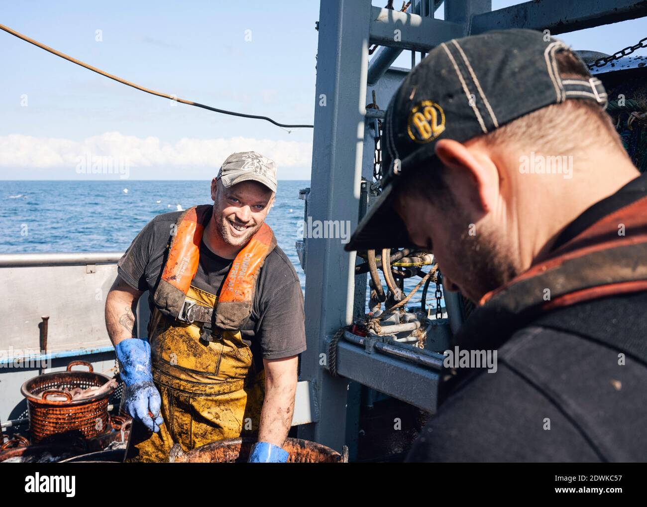 Simon and Kieran gut and clean the fish they have caught before storing ...