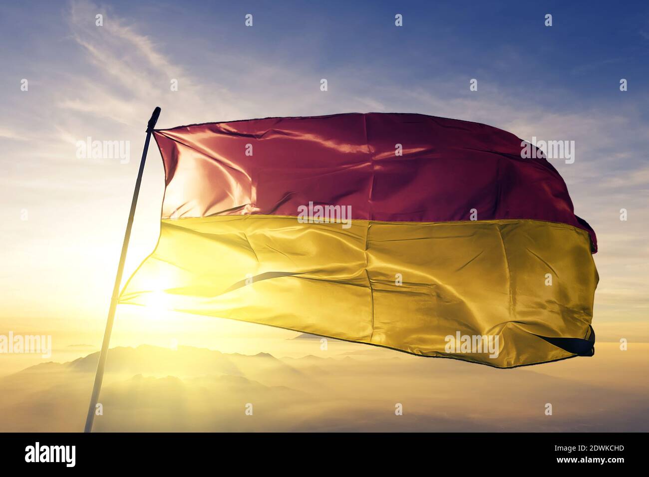 Azuay Cuenca province of Ecuador flag waving on the top sunrise mist ...