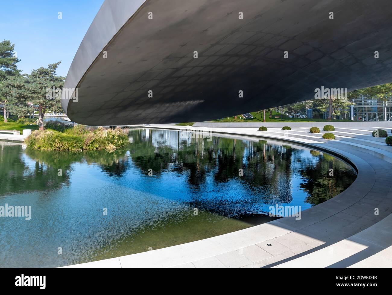 The streamlined pavilion with a curled-over steel roof for Porsche at ...