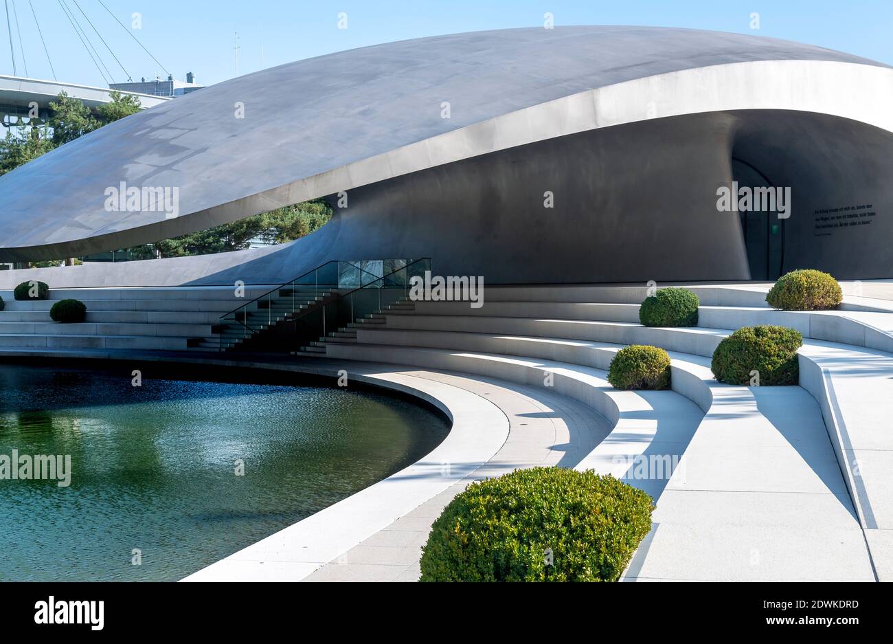 The streamlined pavilion with a curled-over steel roof for Porsche at ...