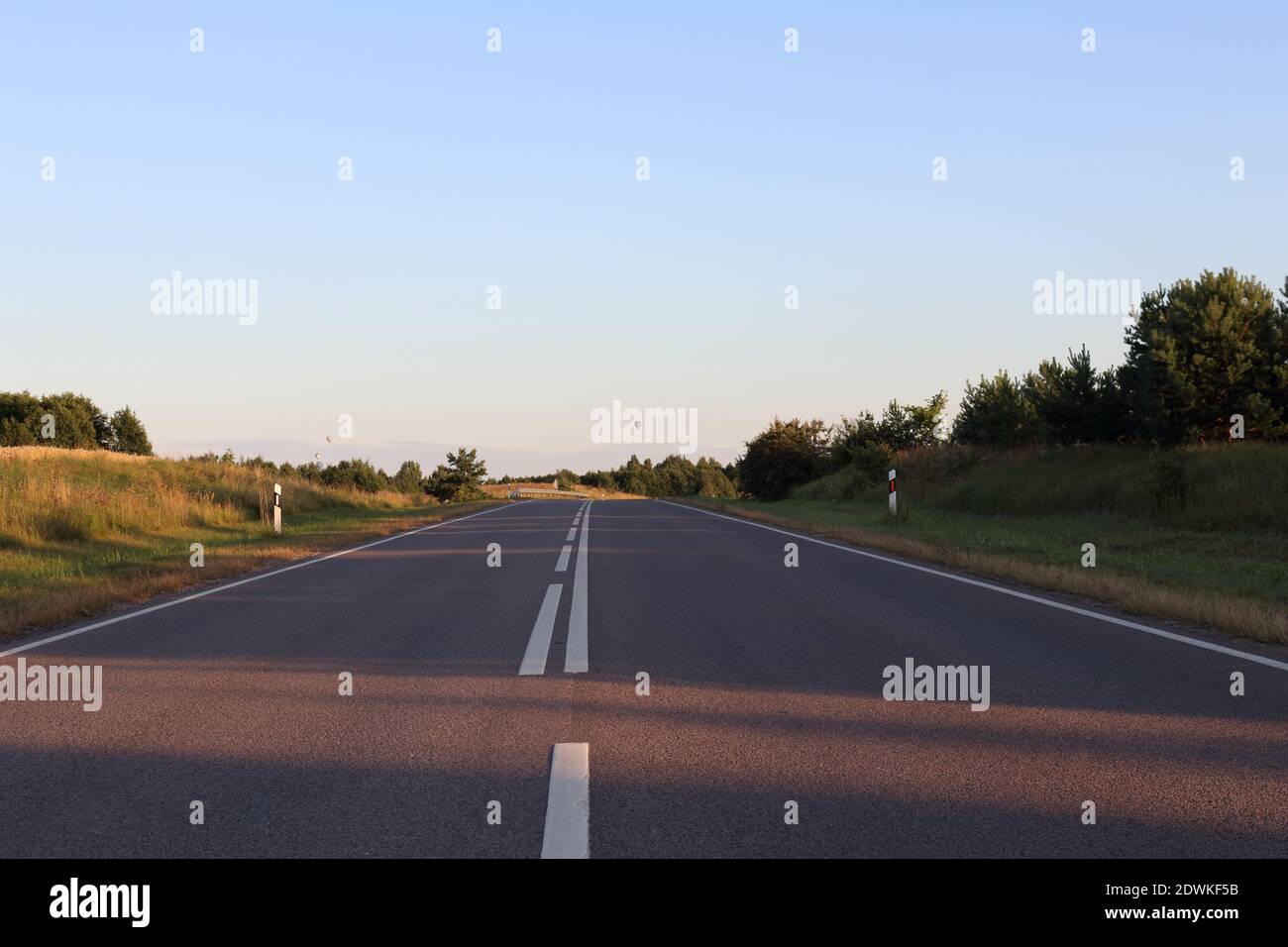 Summer road at sunset Stock Photo - Alamy