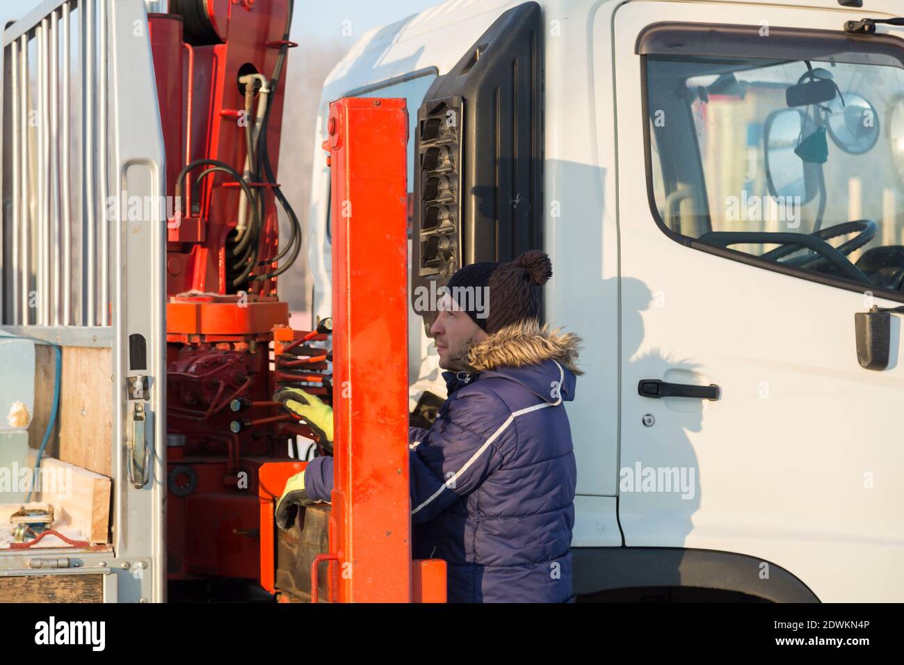The hydraulic manipulator driver focuses on crane control Stock Photo ...