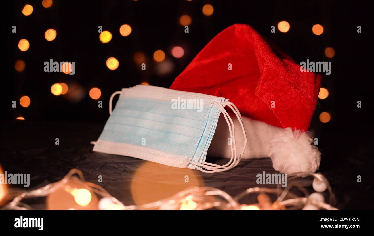 Red Santa Claus Cap and Medical Masks on the Background of Christmas ...
