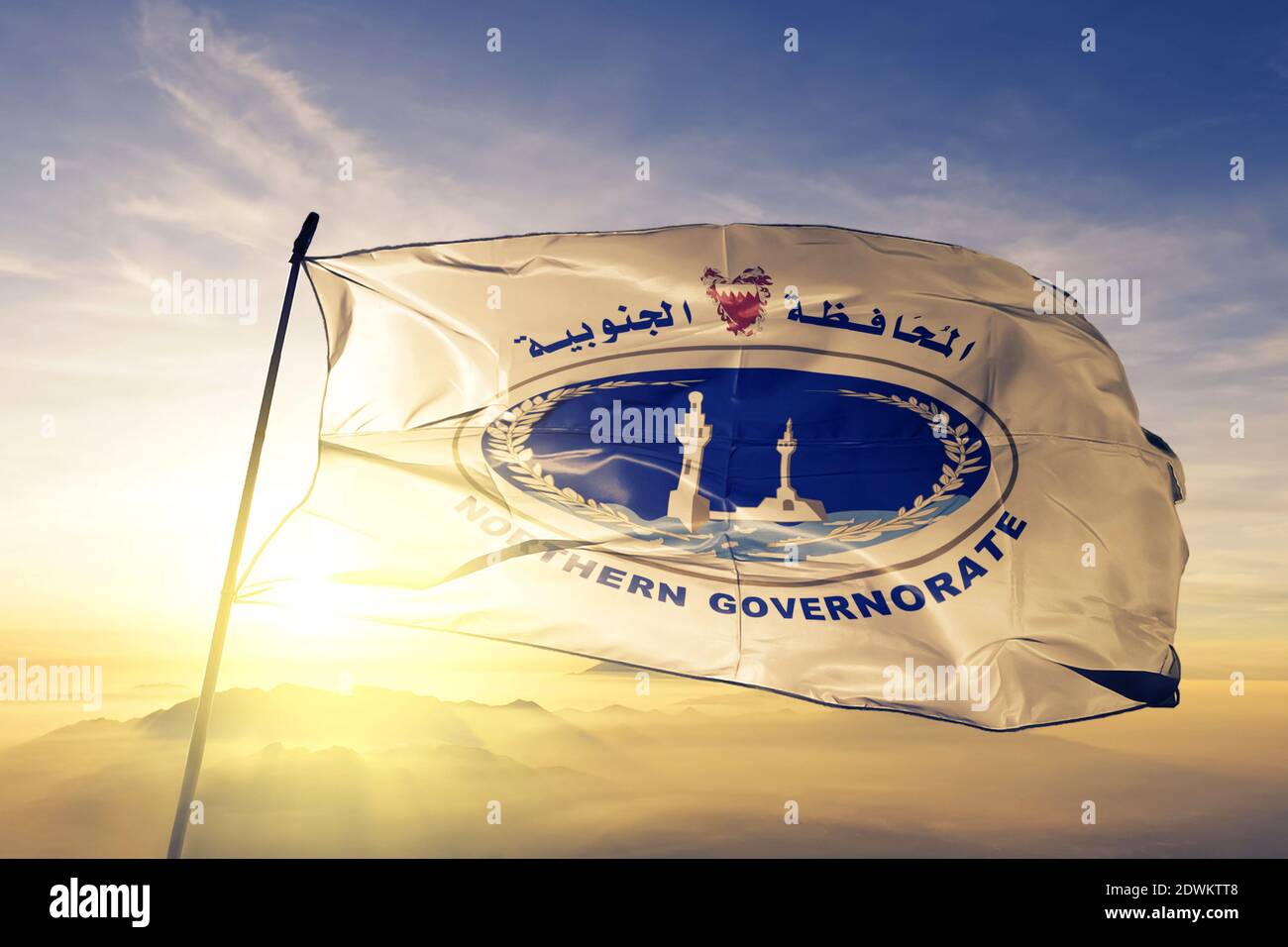 Northern governorate of Bahrain flag waving on the top sunrise mist fog ...
