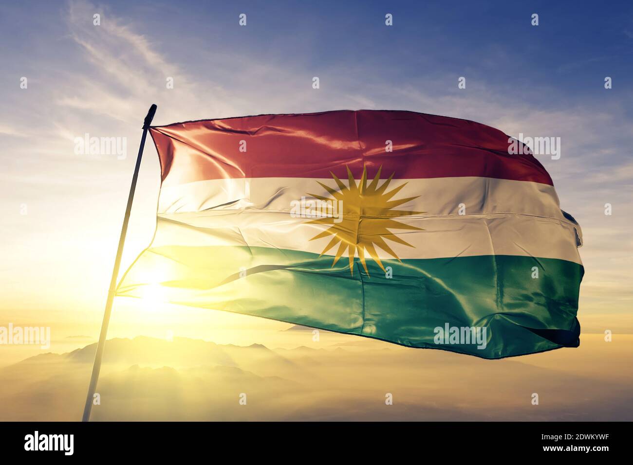 Kurdistan flag waving on the top sunrise mist fog Stock Photo - Alamy