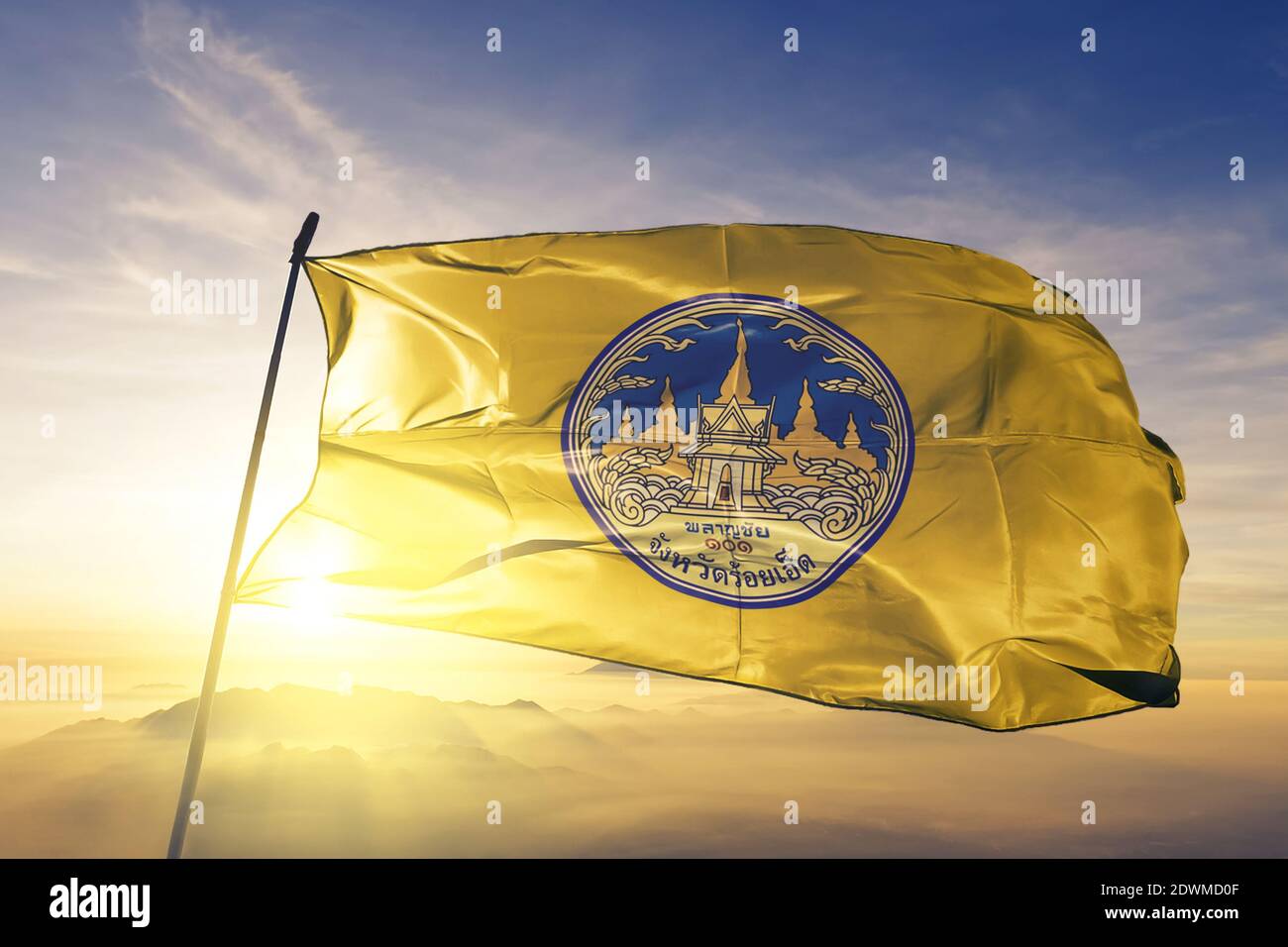 Roi Et province of Thailand flag waving on the top sunrise mist fog ...