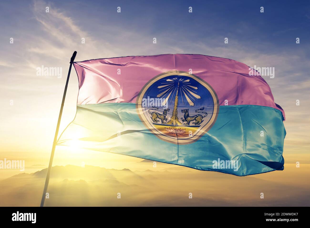 Yasothon province of Thailand flag waving on the top sunrise mist fog ...