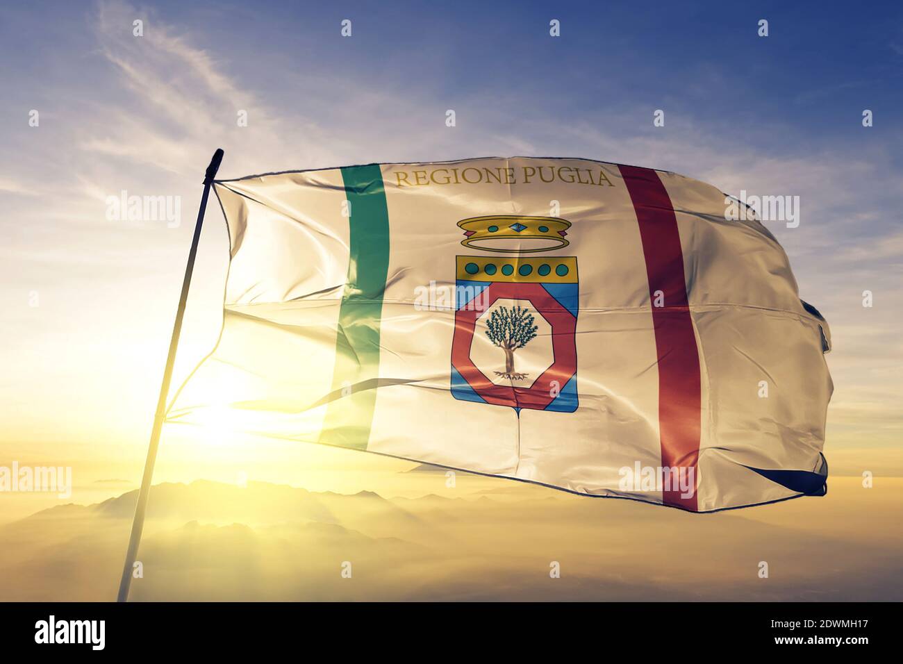 Apulia region of Italy flag waving on the top sunrise mist fog Stock ...