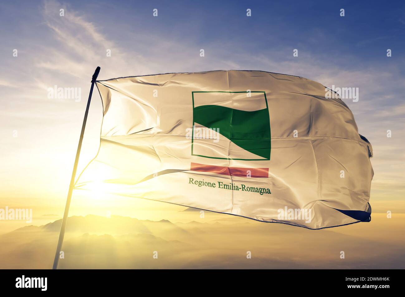 Emilia-Romagna region of Italy flag waving on the top sunrise mist fog ...