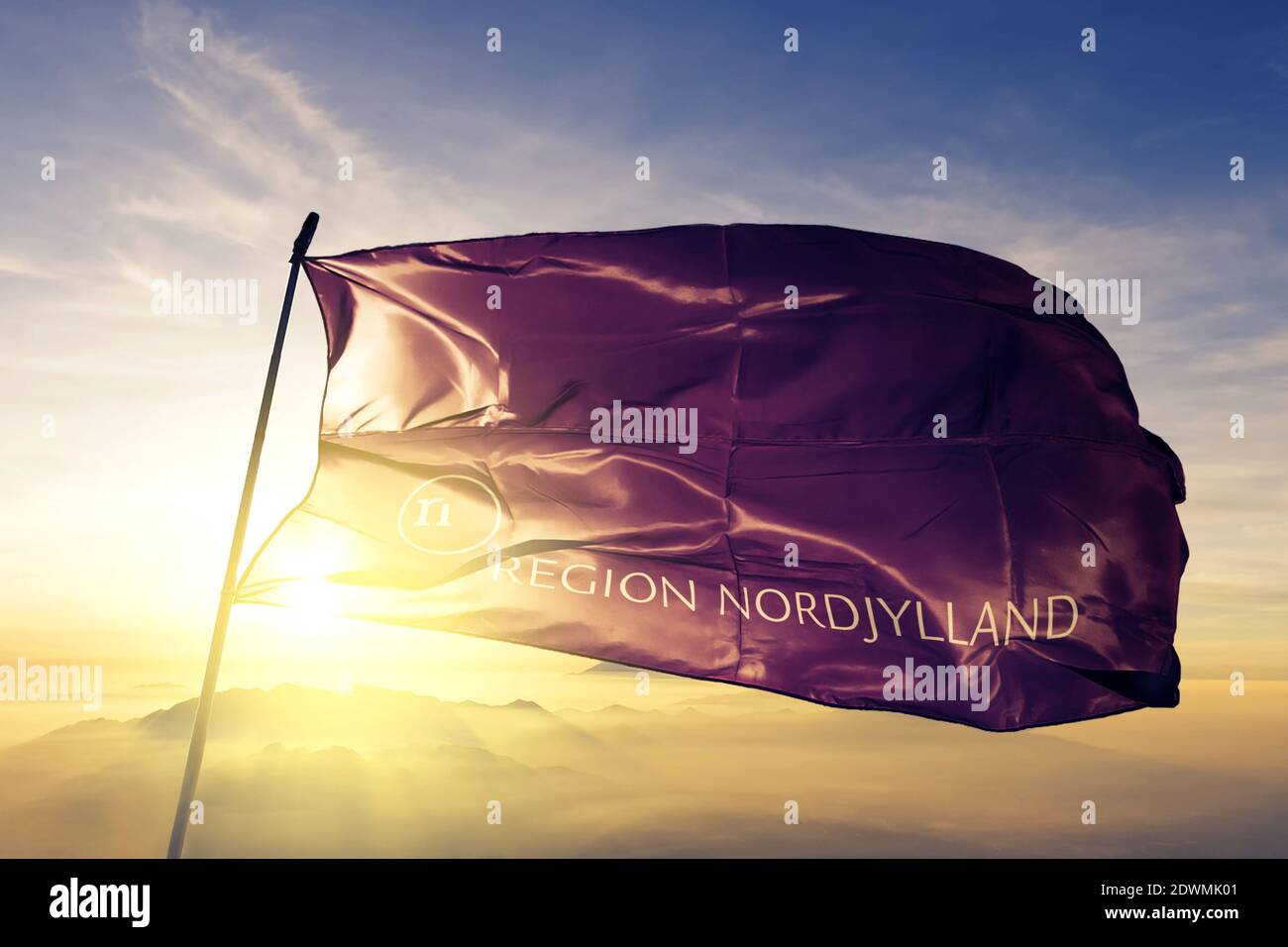 North Jutland Region of Denmark flag waving on the top sunrise mist fog ...