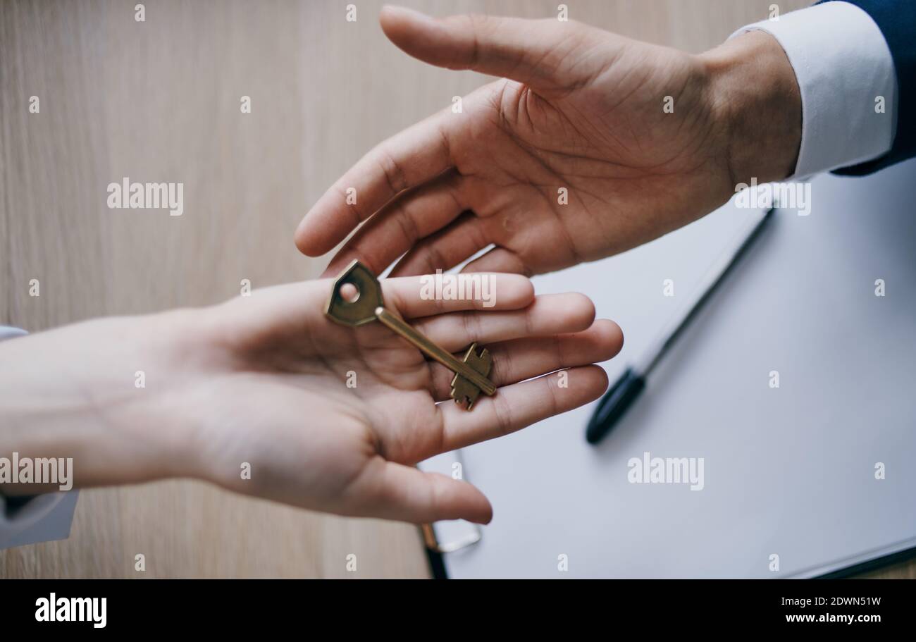 handing the key from hand to hand to the office business finance work ...
