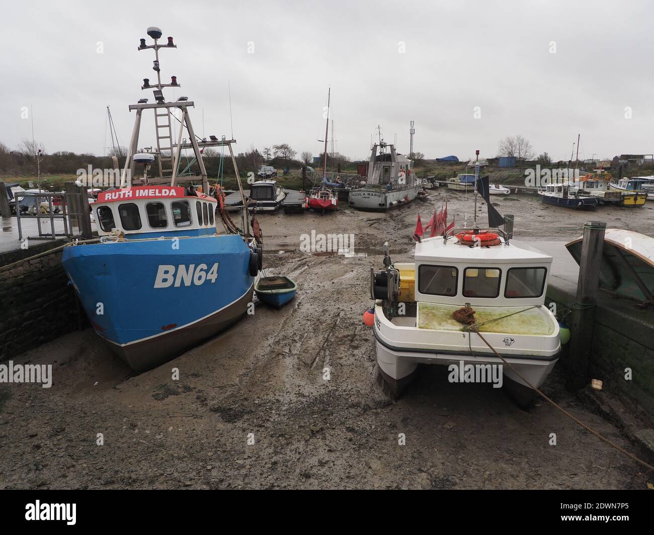 Queenborough, Kent, UK. 23rd December, 2020. Fishing boats at low tide ...